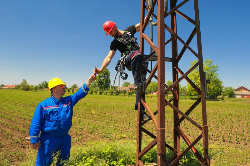 Two Tehnicians Are Working On Power Transmission Line Stock Image ...