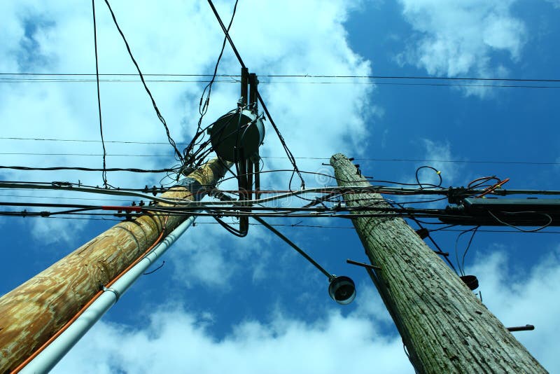 Two Telephone Poles Against a Blue but Cloudy Sky Stock Image - Image ...