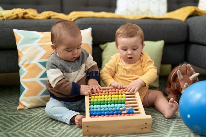 Two Toddlers Playing with Abacus Sitting on Floor at Home Stock Photo ...