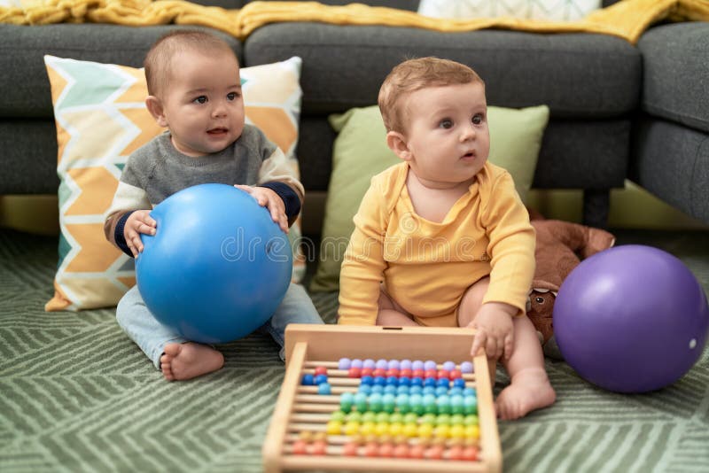 Two Toddlers Playing with Balls and Abacus Sitting on Floor at Home ...