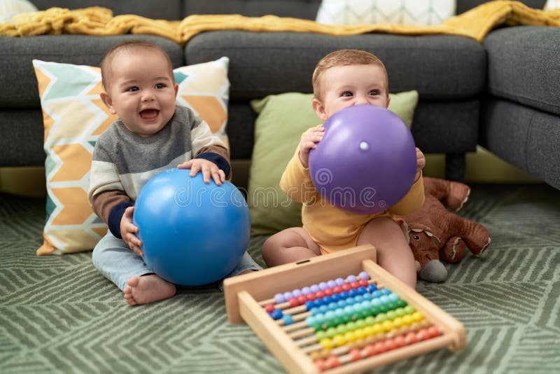 Two Toddlers Playing with Balls and Abacus Sitting on Floor at Home ...