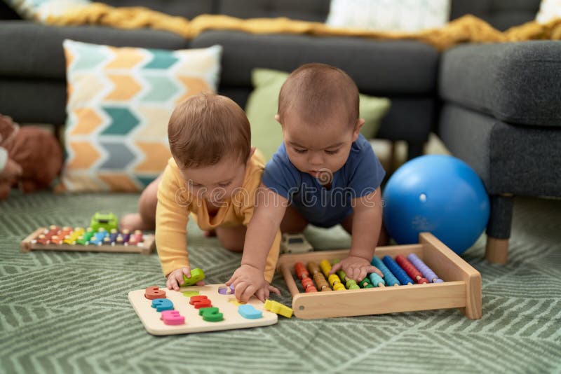 Two Toddlers Playing with Maths Toys Sitting on Floor at Home Stock ...