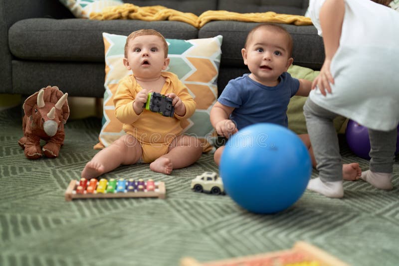Two Toddlers Playing with Toys Sitting on Floor at Home Stock Photo ...