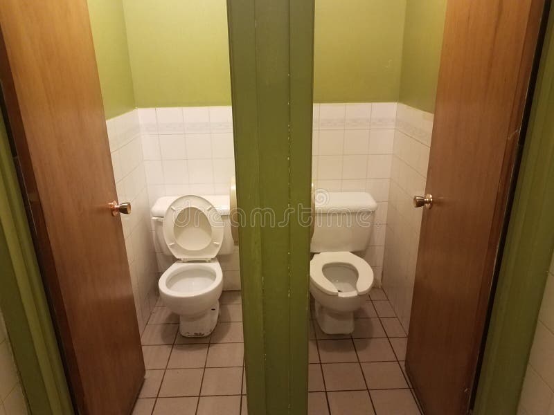 Two Toilets with Stalls in Green and White Bathroom Stock Image - Image ...