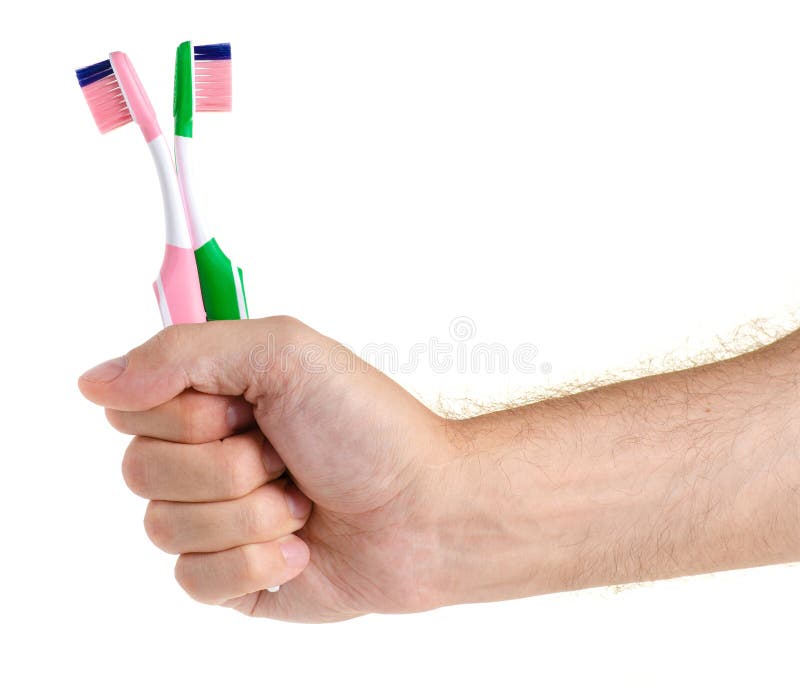 Two toothbrushes in hand stock photo. Image of green - 119987598