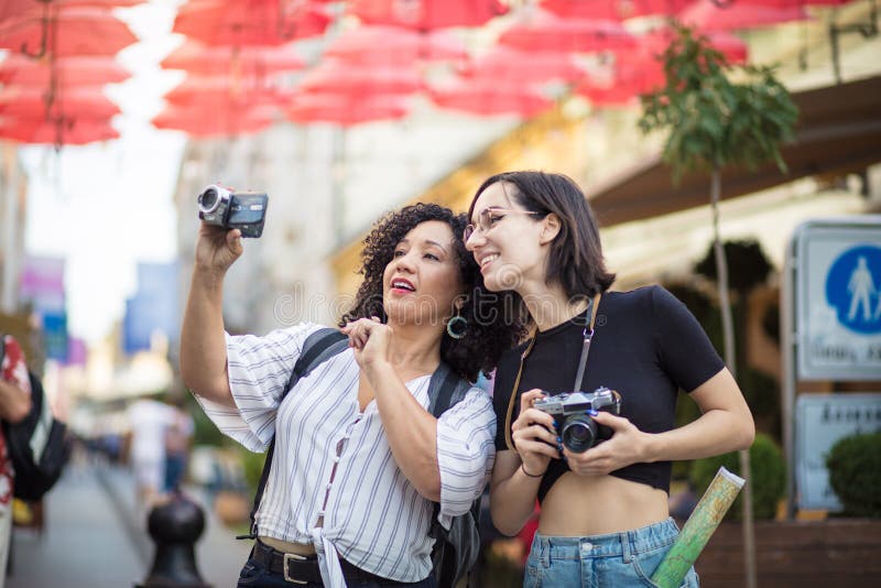 Two Tourist Women on Street with Camera Stock Image - Image of outdoor ...
