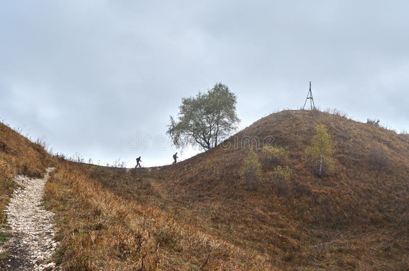 Two Tourists Climb the Path To the Top of the Mountain. Stock Photo ...