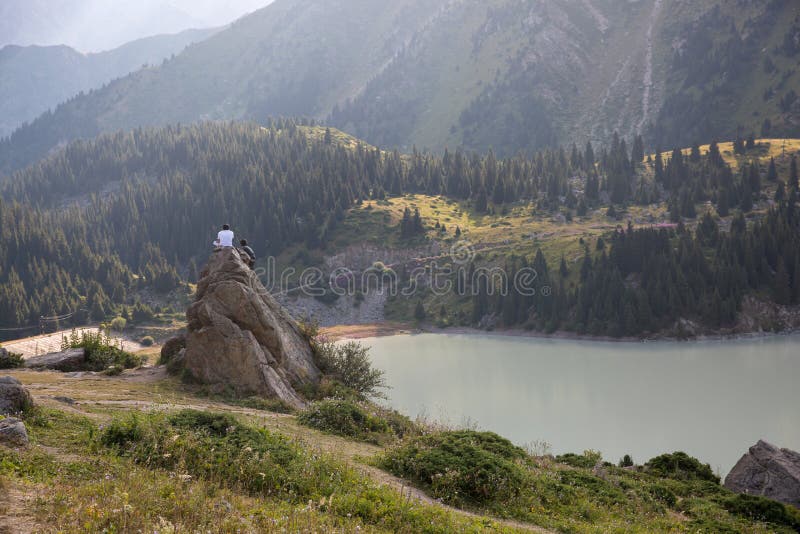 Two Tourists Sitting on a High Hill Choose the Route of Movement Stock ...