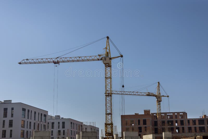 Two Tower Cranes Near Building with Concrete Building Under ...
