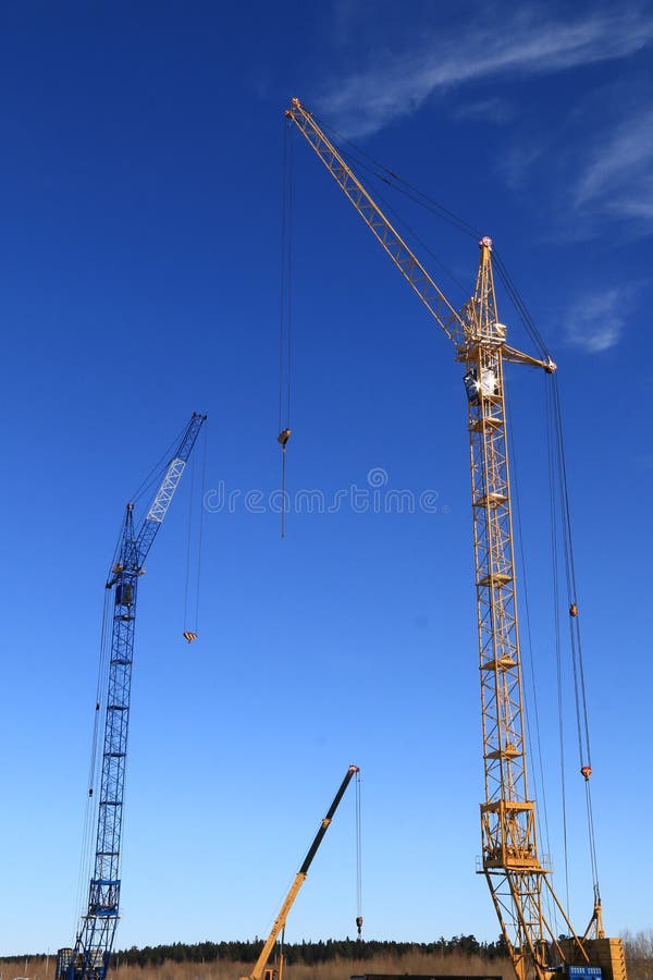 Two Tower Cranes and a Truck Crane at a Construction Site Stock Photo ...