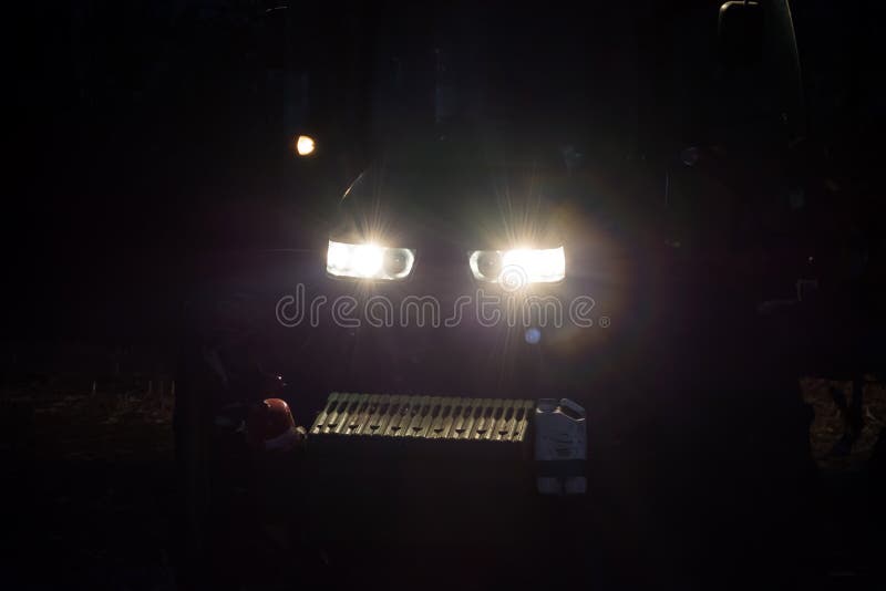 Two Tractor Plowing the Land Late at Night with the Headlights on Stock ...