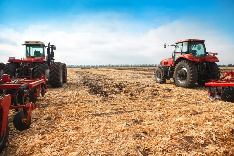 Two tractors in a field. stock image. Image of machine - 92109169