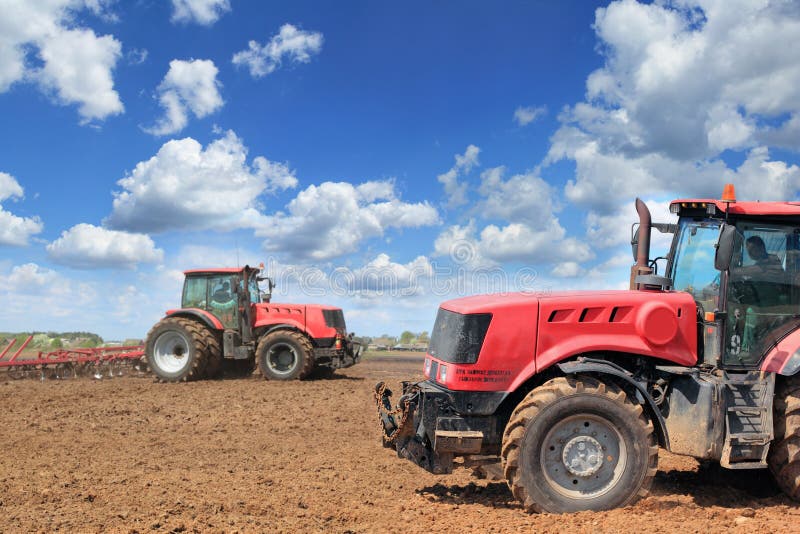 Two tractors on the field editorial stock image. Image of clouds - 53945414