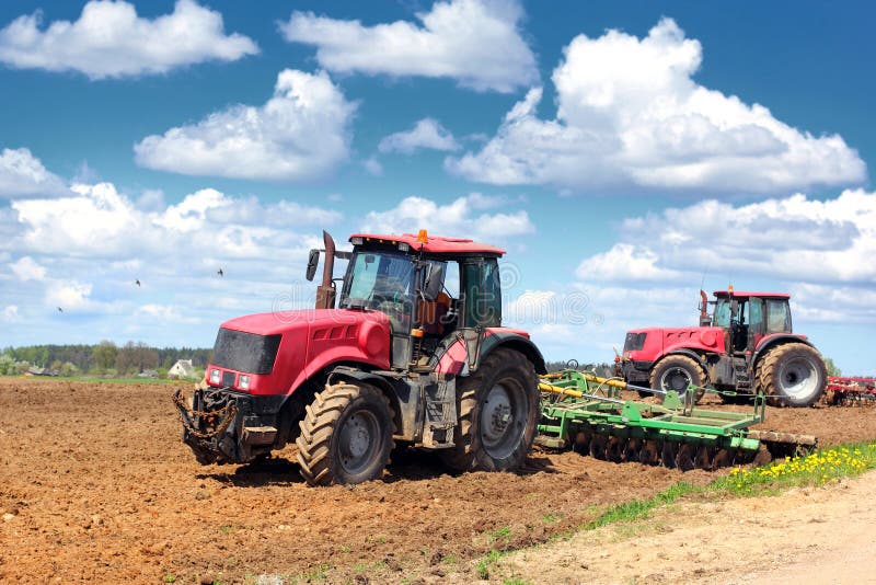 Two tractors on the field stock image. Image of food - 53935789