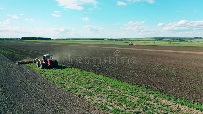 Two Tractors Plow Big Field on a Farm. Stock Video - Video of ...