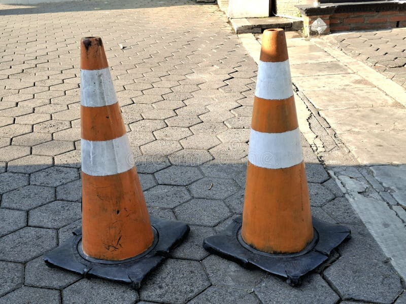 Two Traffic Cones on a Parking Lot in Front of a Building Stock Photo ...