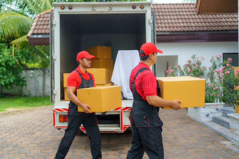 Two Transport Workers Unloading Boxes in Order To Move To a New House ...
