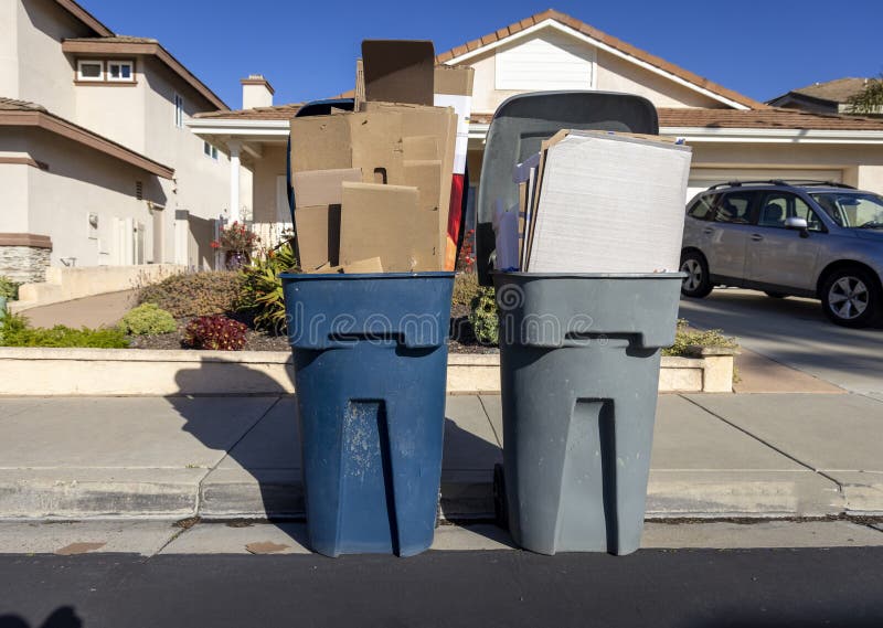 Two Trash Cans Overflowing with Garbage on a Suburban Street Stock ...