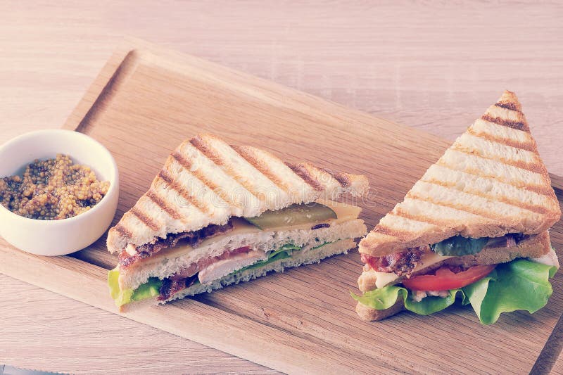 Two Triangular Sandwich with Bacon and Chicken Breast and White Stock ...