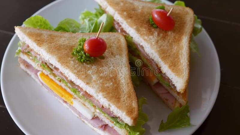Two Triangular Sandwiches with Ham, Cheese, Egg, Lettuce, Bacon, Cherry ...