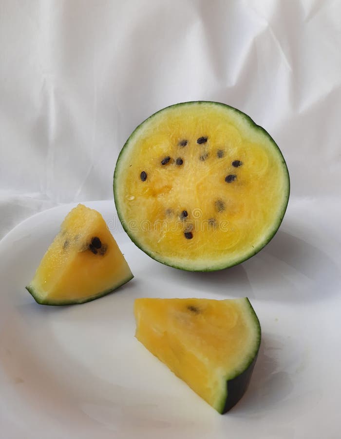 Two Triangular Slices and Half of a Watermelon with Yellow Flesh Stock ...
