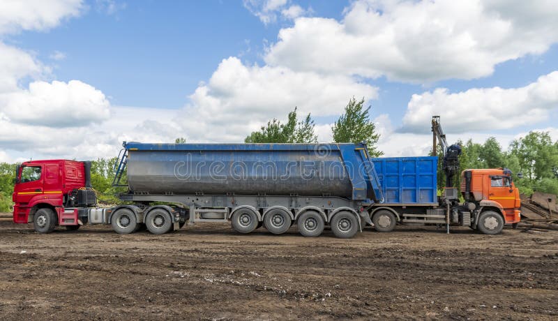 Two Large Trucks for Transporting Scrap Metal are Parked at the Loading ...