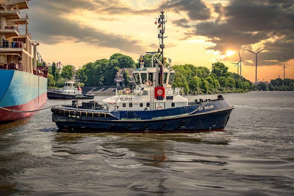 Two Tugboats during the Work of Navigating a Container Ship Editorial ...