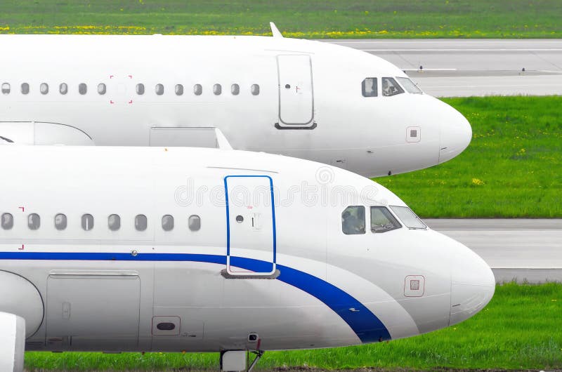Two Twin Airplanes on the Runway at the Airport Stock Photo - Image of ...