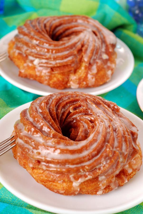 Two Twisted Donuts with Icing Stock Photo - Image of dessert, rolled ...