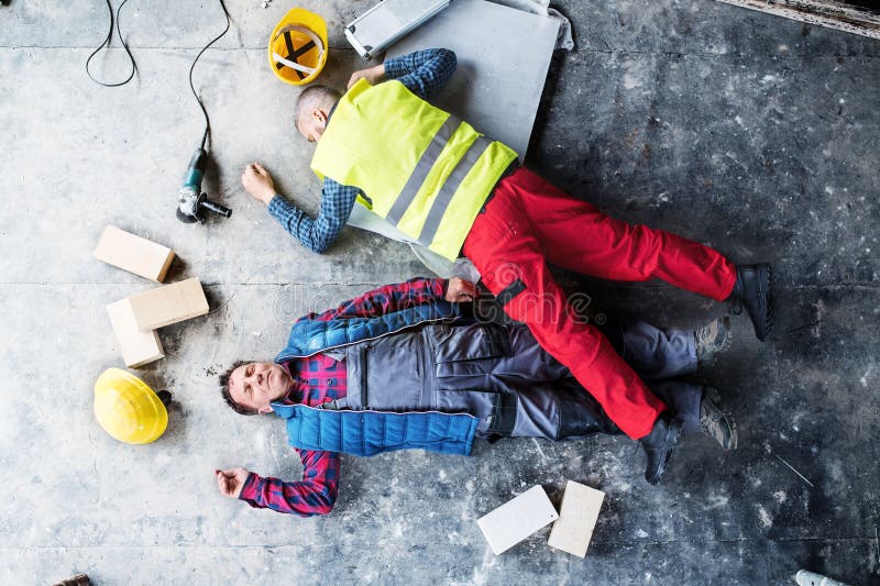 Two Unconscious Man Workers Lying on the Floor after a Fall. Work ...