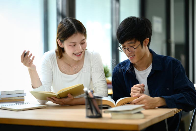 Two University Students Sharing Ideas while Studying Together in a ...