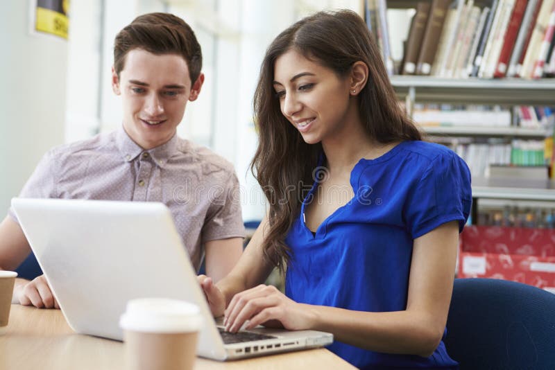 Two University Students Working in Library Using Laptop Stock Photo ...