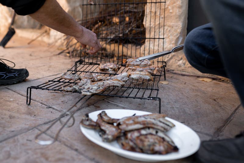 Two Unrecognizable Men are Taking the Cooked Meat from the Grill after ...