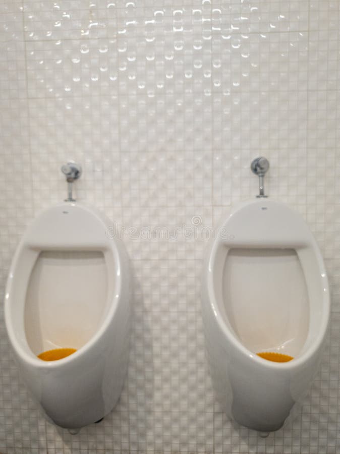 Two Urinals Next To White Tiled Wall Stock Photo - Image of wall ...
