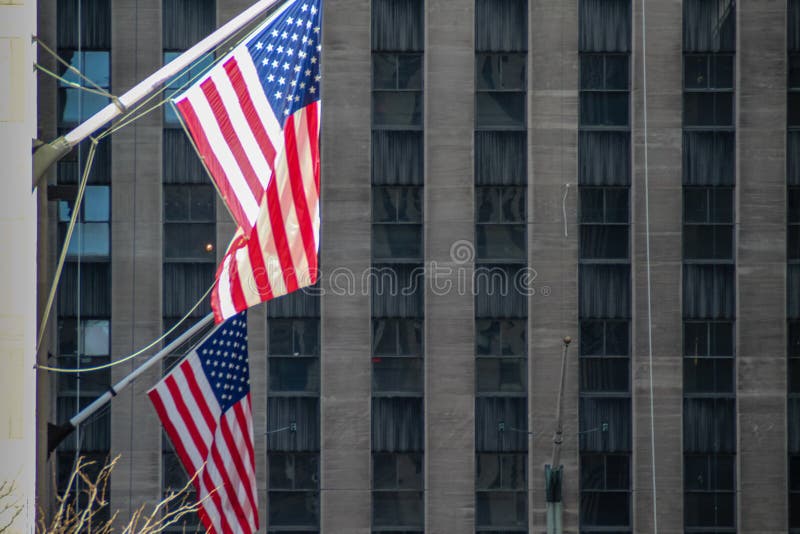 Two USA Flags on the Building Facade with Scyscrapper at the Backgroumd ...