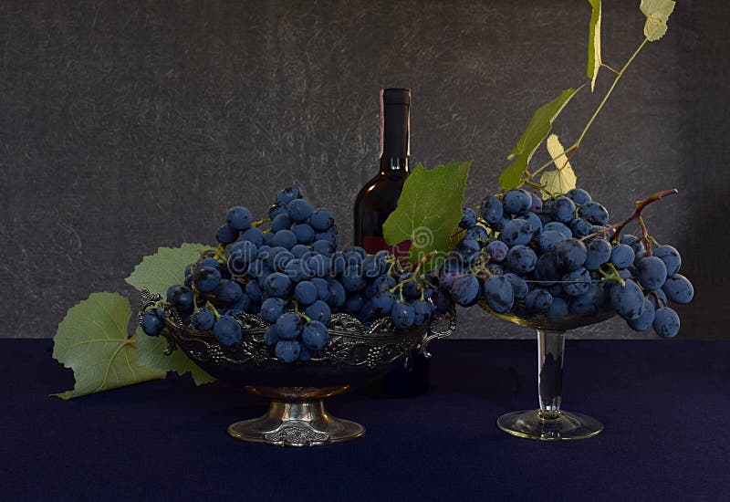 Two Varieties of Grapes and a Bottle of Wine Stock Photo - Image of ...