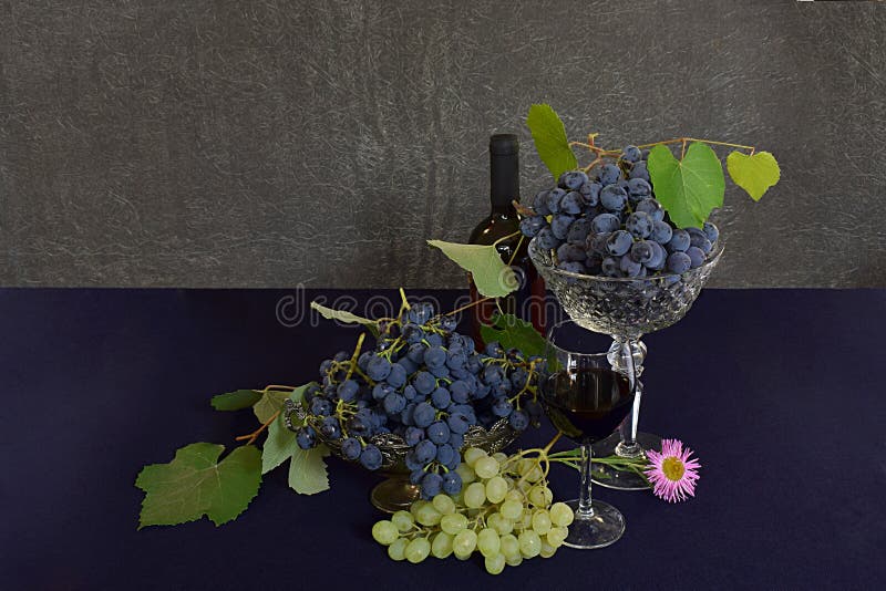 Two Varieties of Grapes and a Bottle of Wine Stock Photo - Image of ...