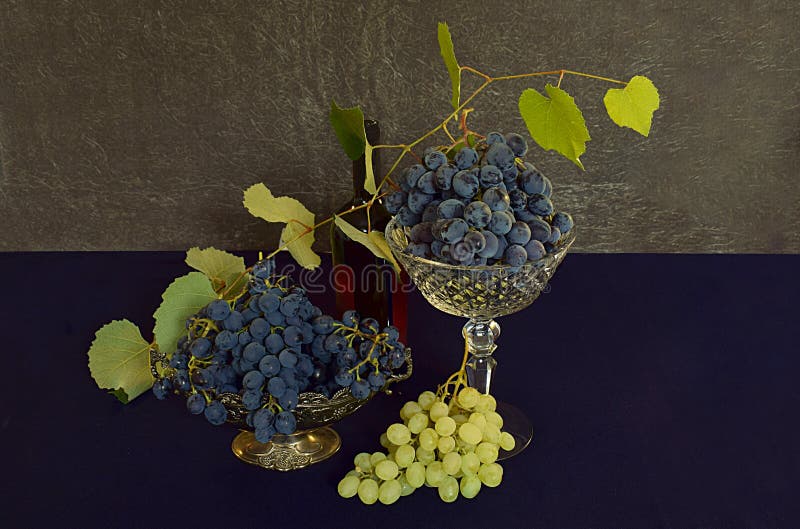 Two Varieties of Grapes and a Bottle of Wine Stock Photo - Image of ...
