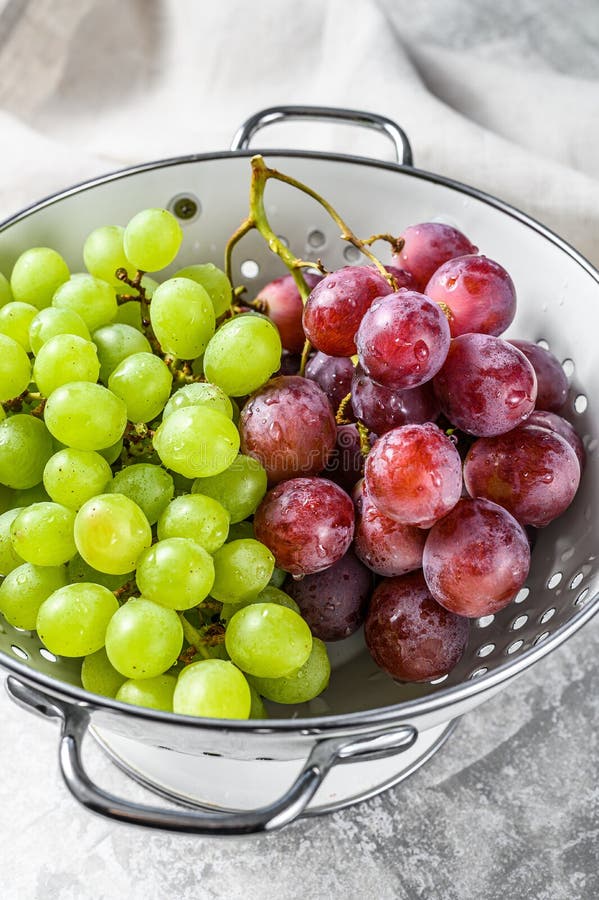 Two Varieties of Grapes, Red and Green in a Colander. Gray Background ...
