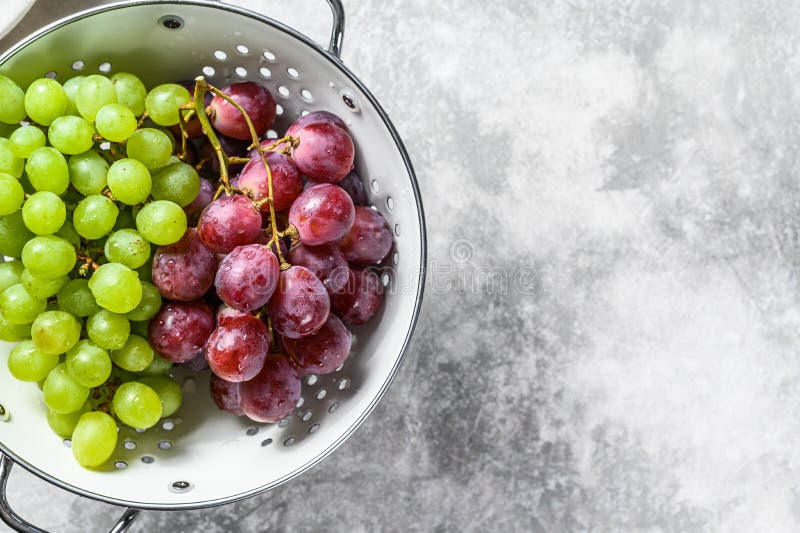 Two Varieties of Grapes, Red and Green in a Colander. Gray Background ...
