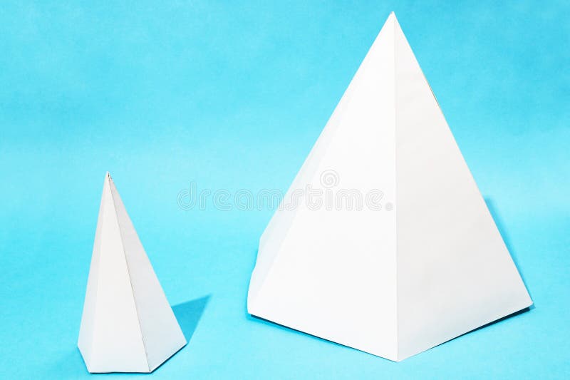 Two Various Hand-crafted Paper Pyramids on Blue Stock Image - Image of ...