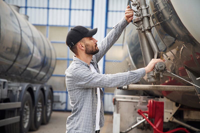 Between Two Vehicles. Young Truck Driver in Casual Clothes Stock Image ...