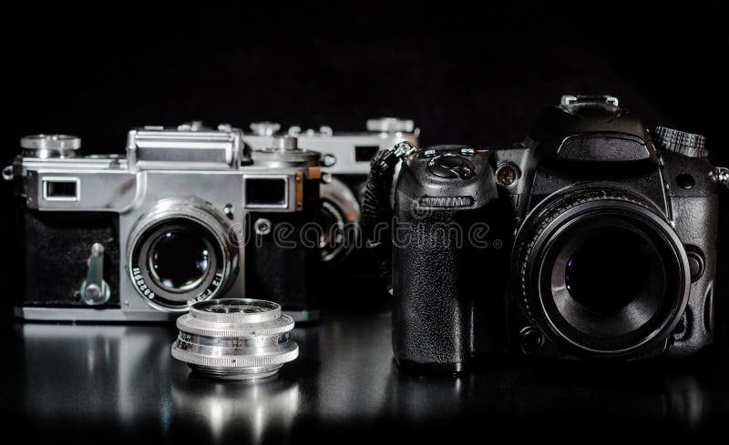 Two Vintage Cameras and One Modern Camera on a Black Background Stock ...