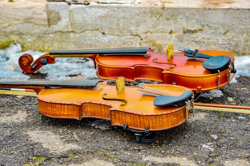 Two Violins Lie on the Asphalt Next To the Snow Stock Photo - Image of ...