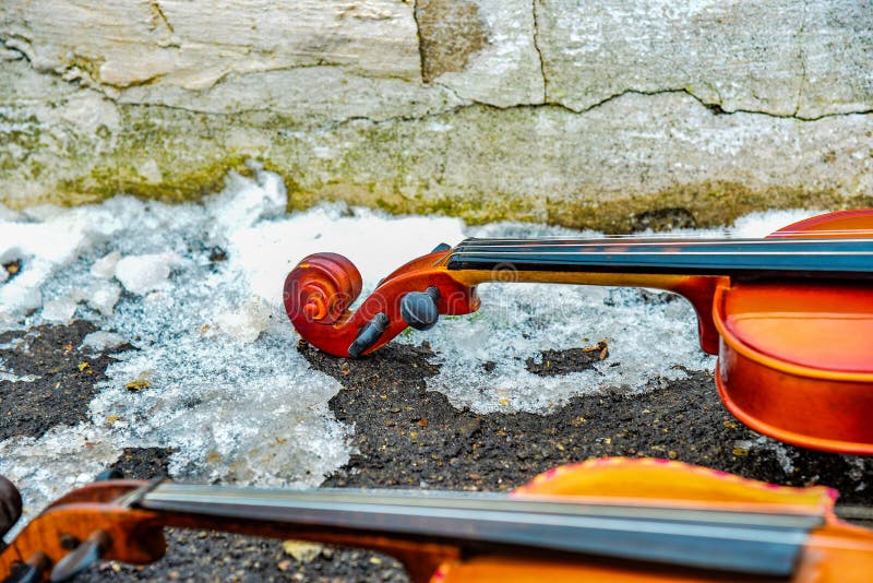 Two Violins Lie on the Asphalt Next To the Snow Stock Photo - Image of ...