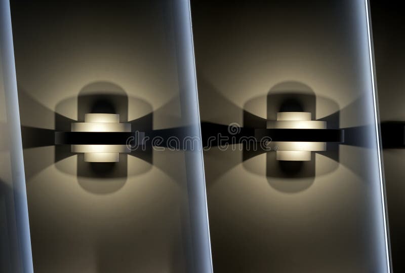 Two Wall Lights with Symmetrical Highlights on the Wall. Stock Photo ...