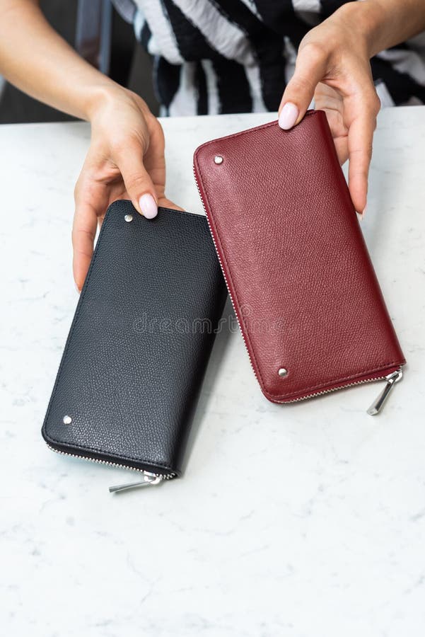 Two Wallets in the Hands of a Girl on a White Table Stock Photo - Image ...