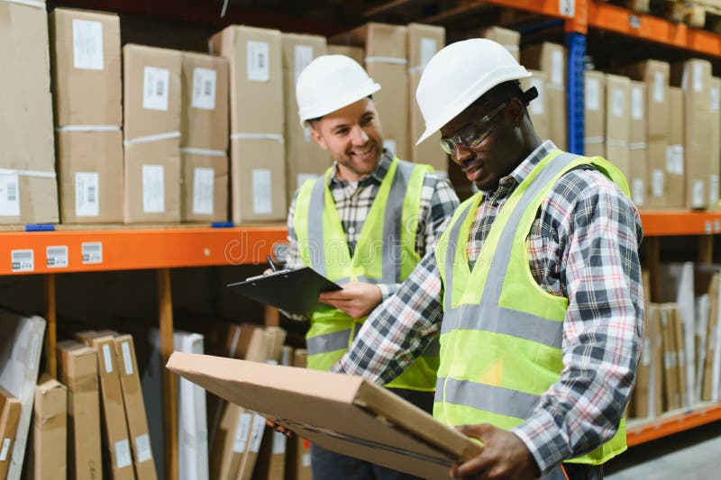 Two Warehouse Workers Checking and Controlling Boxes in Warehouse ...