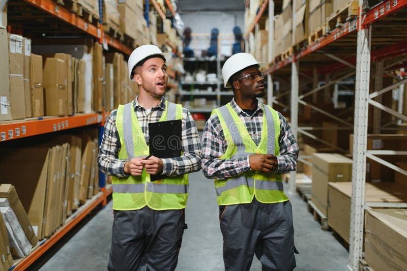 Two Warehouse Workers Checking and Controlling Boxes in Warehouse ...
