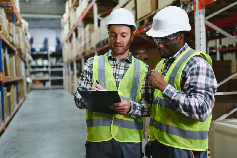 Two Warehouse Workers Checking and Controlling Boxes in Warehouse ...